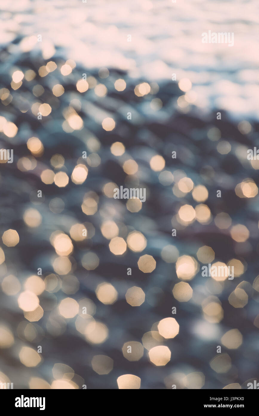 out of focus blur background with sea water in sunset light - retro ...