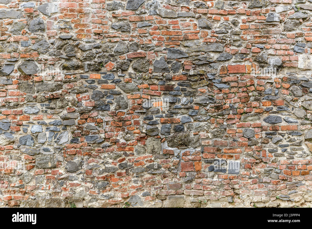 Uneven stone and brick wall pattern, texture or background Stock Photo ...