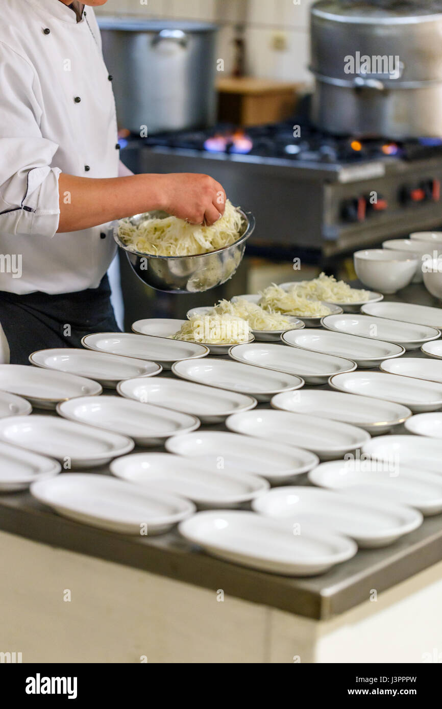 Busy cook at work in the restaurant kitchen Stock Photo - Alamy