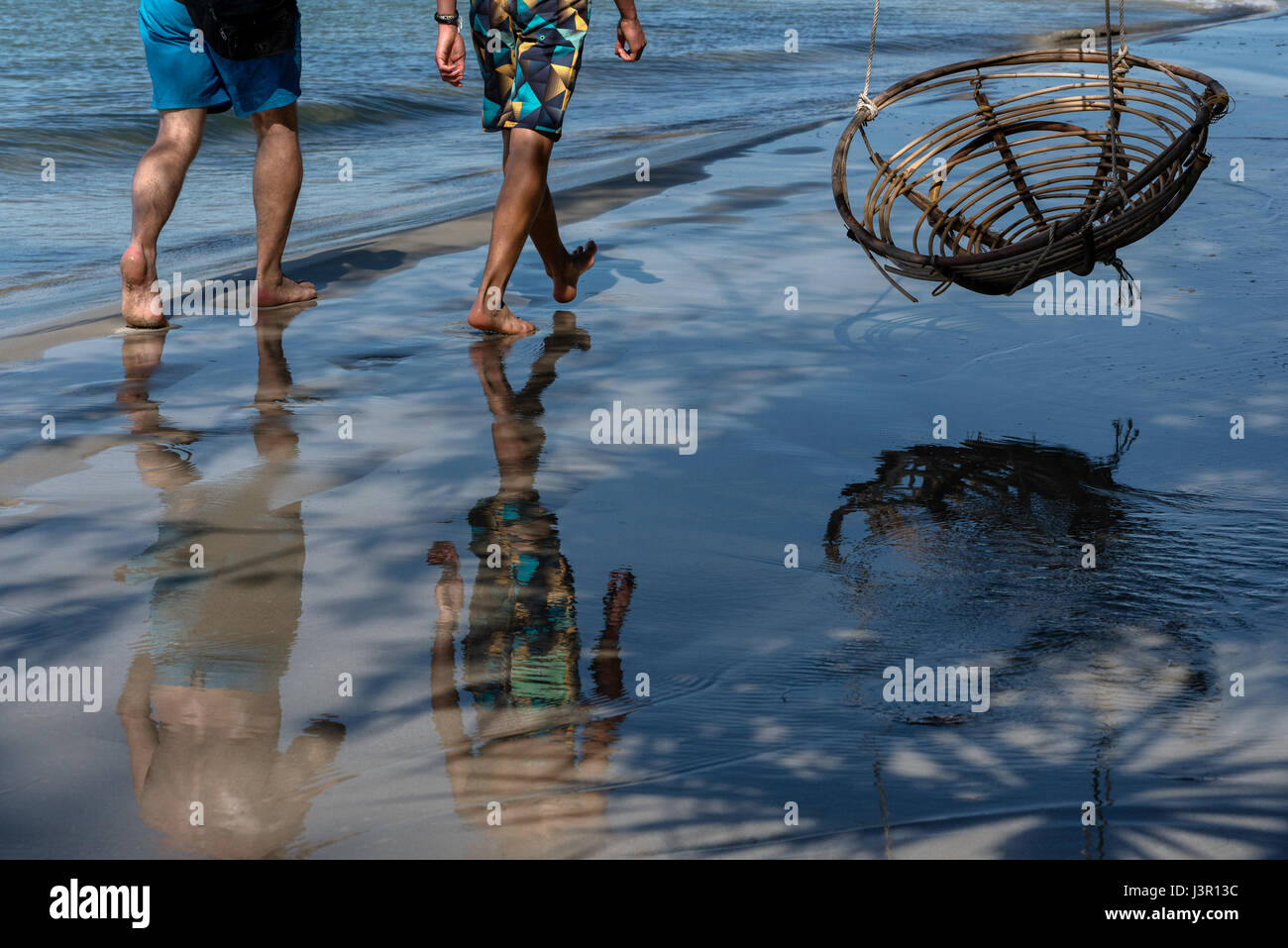 Men walking on the beach in Cambodia Stock Photo - Alamy