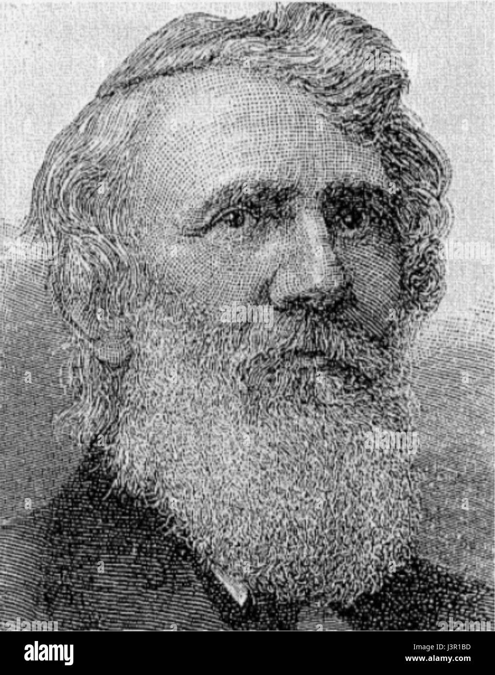 A photograph of John Carlin, a prominent figure, possibly in the arts ...