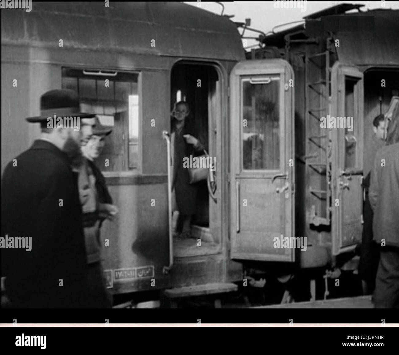 This historical photograph captures Jewish individuals at a railway ...