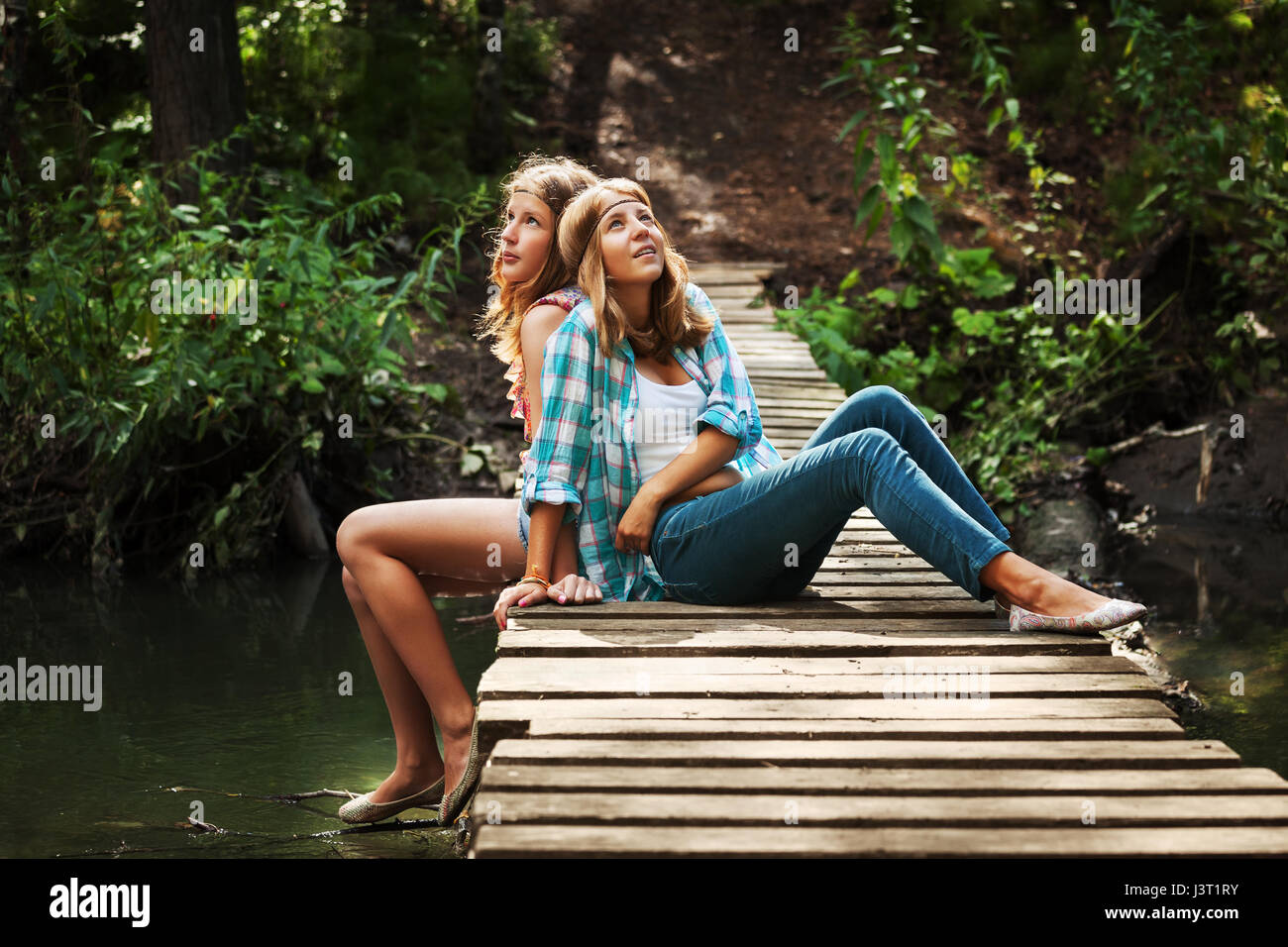 Two friends sitting on bridge hi-res stock photography and images - Alamy