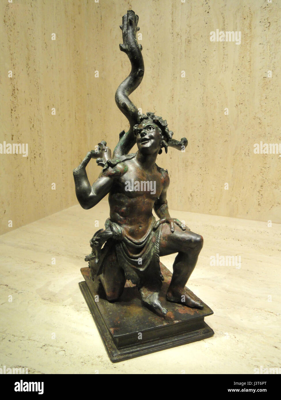 This ancient Greek statue, known as the *Kneeling Satyr*, is believed ...