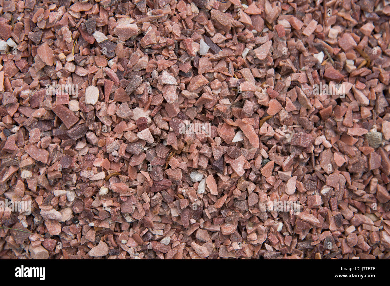 Concrete wall with brick-red pebbles for use as background Stock Photo ...