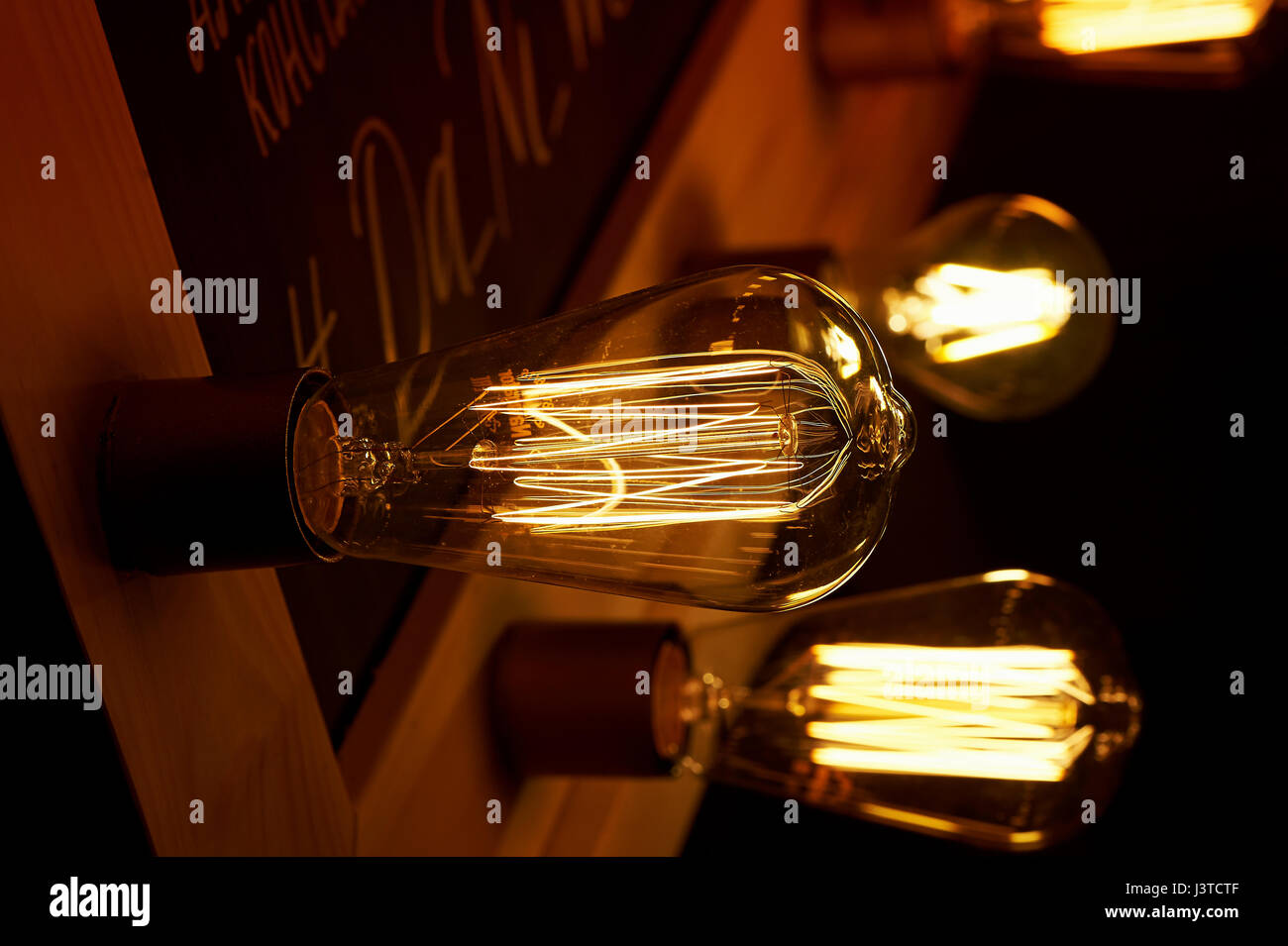 Edison light bulb hanging on a long wire. Cozy warm yellow light.Retro ...