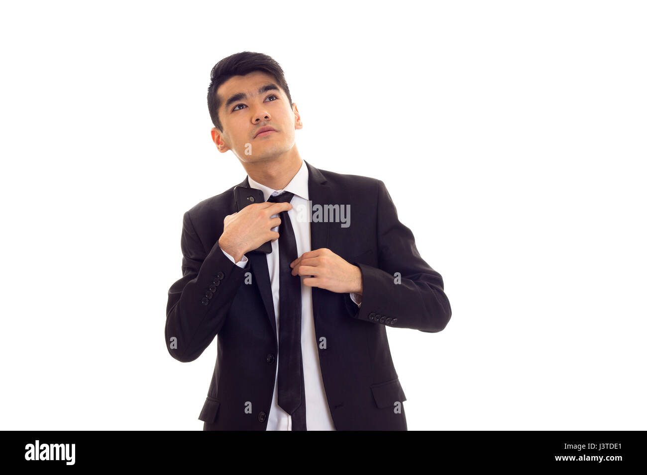 Young man in suit talking on the phone Stock Photo - Alamy