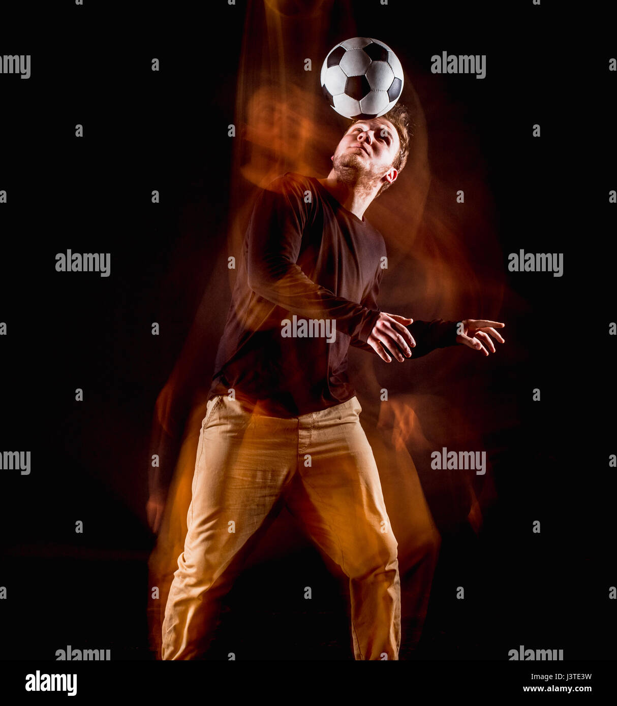 A portrait of a fan with ball on gray studio background. Freestile ...