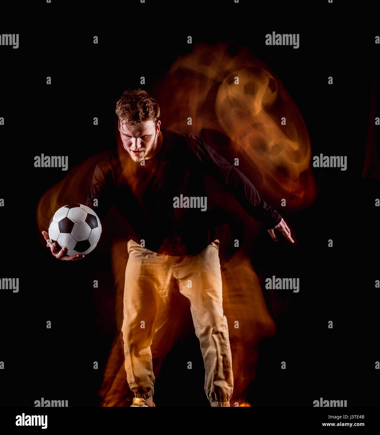 A portrait of a fan with ball on gray studio background. Freestile ...