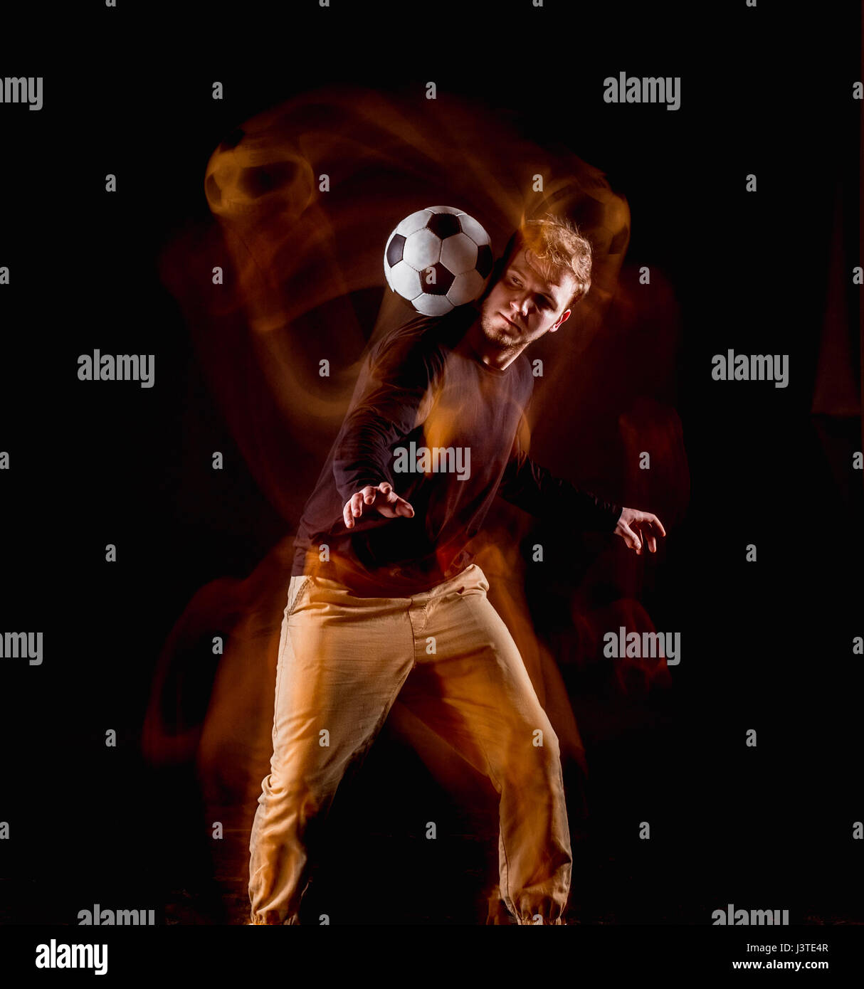 A portrait of a fan with ball on gray studio background. Freestile ...