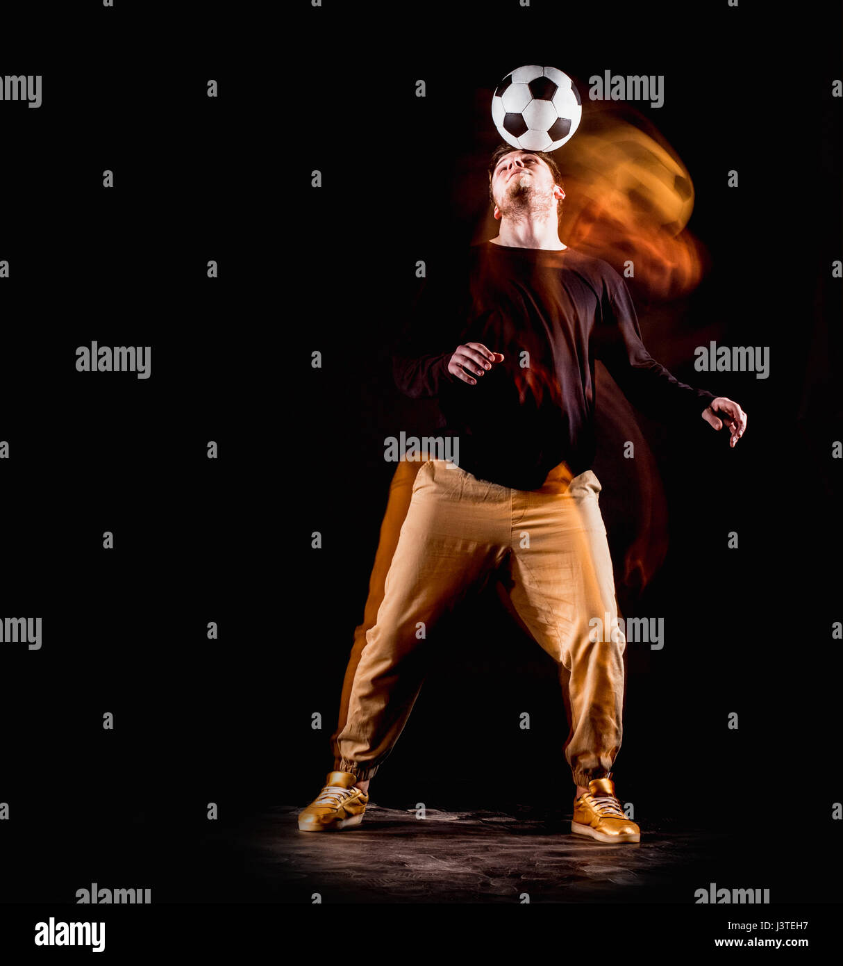 A portrait of a fan with ball on gray studio background. Freestile ...