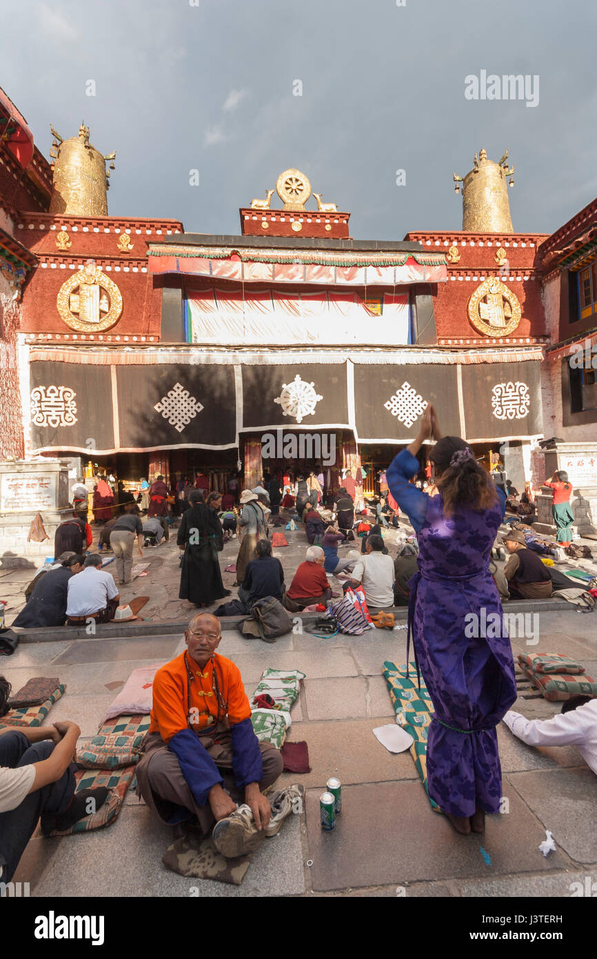 Tibetan Buddhist pilgims performing prostration in front of Jokhang ...