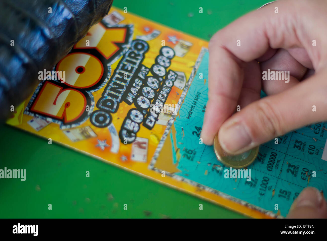 Hand scratching a Lottery Scratchcard with coin, Portugal Stock Photo ...