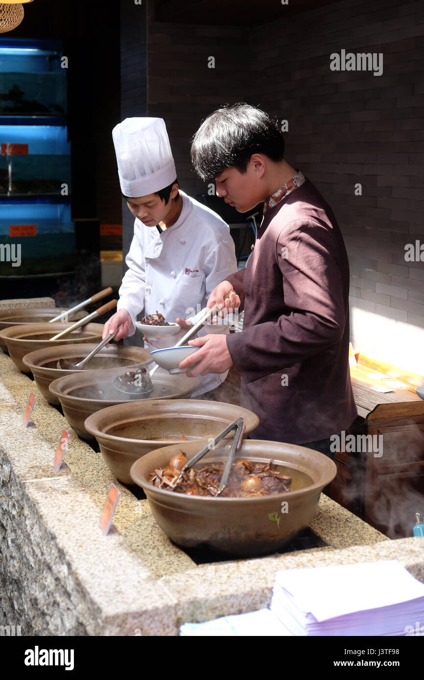 The chefs prepare traditional Chinese food at the restaurant on the ...