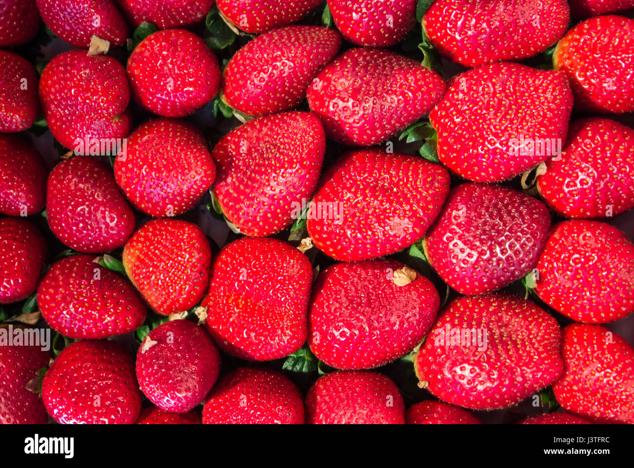 A background of fresh strawberry at the market San Miguel in Madrid ...