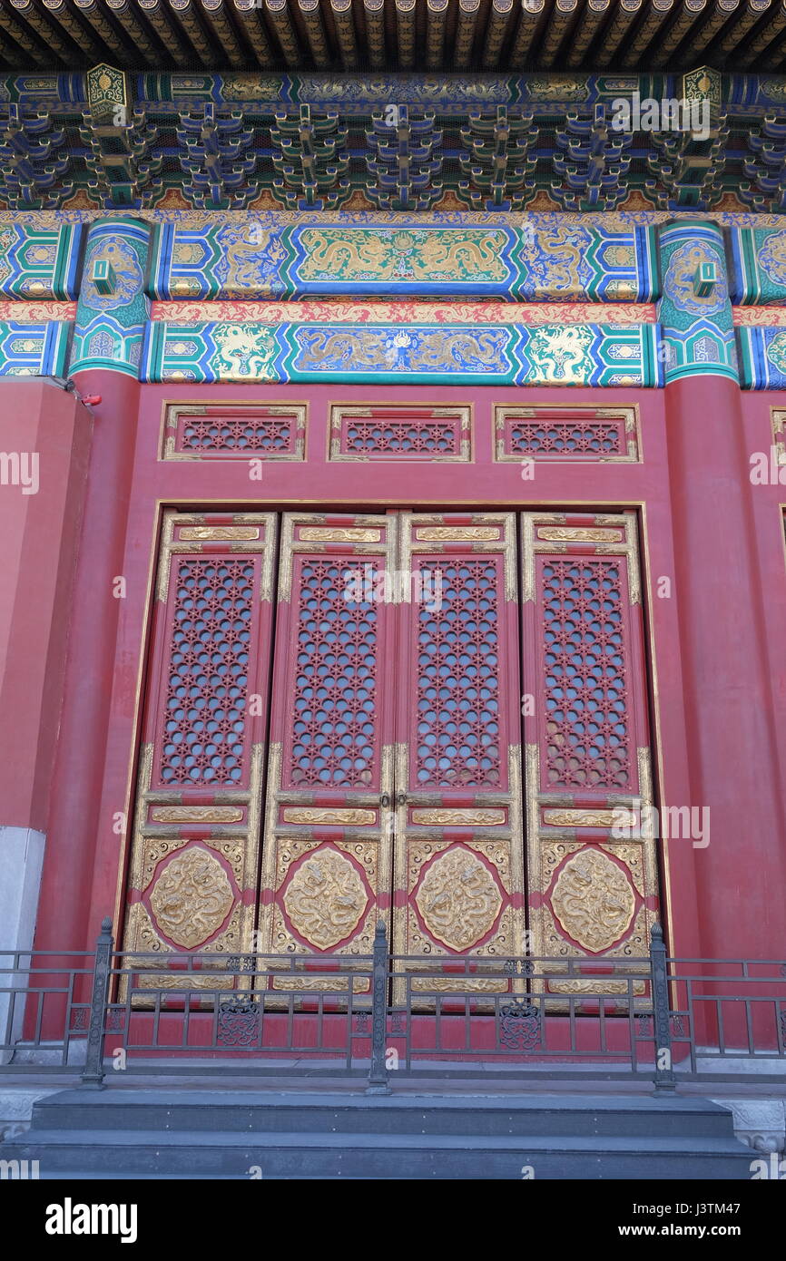 An ornate painted door on a building in the Forbidden City in Beijing ...