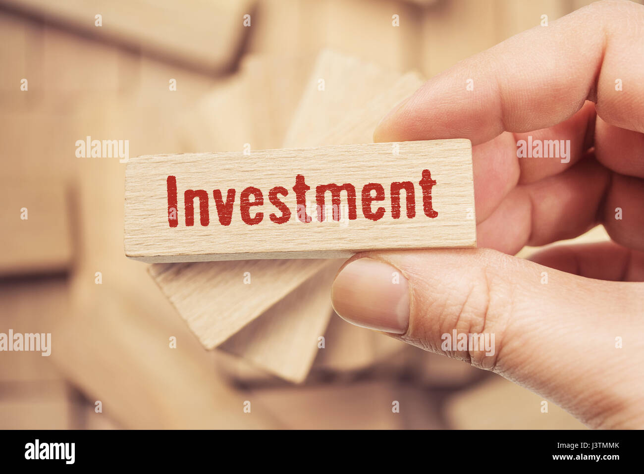 investment word written on wood block Stock Photo - Alamy