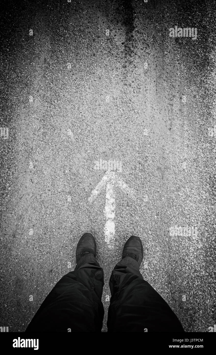 Feet in front of an arrow, detail of a direction arrow, sign Stock ...