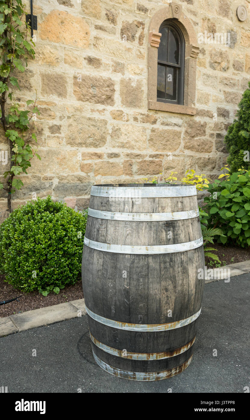 Old wooden wine barrel standing by stone wall of winery Stock Photo - Alamy