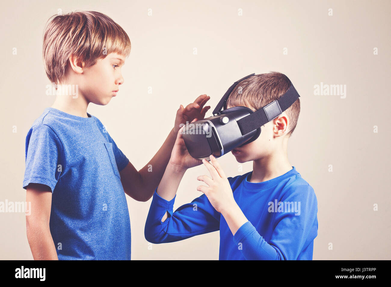 Kids trying virtual reality VR glasses at home Stock Photo - Alamy