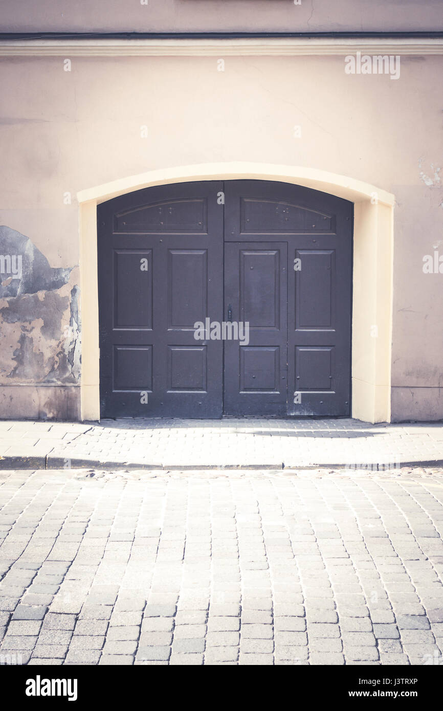 Urban background. Street view to front side of old house with double ...