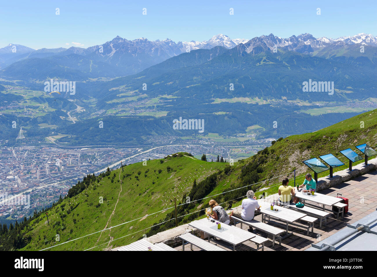People sitting on wooden benches outside the restaurant at Seegrube ...