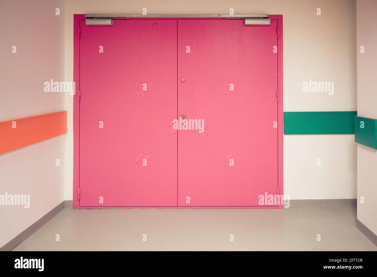 Closed colorful double door along in the corridor Stock Photo - Alamy