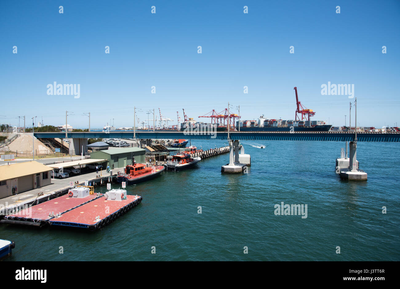 Commercial dock and port with industrial cranes, nautical vessels and ...