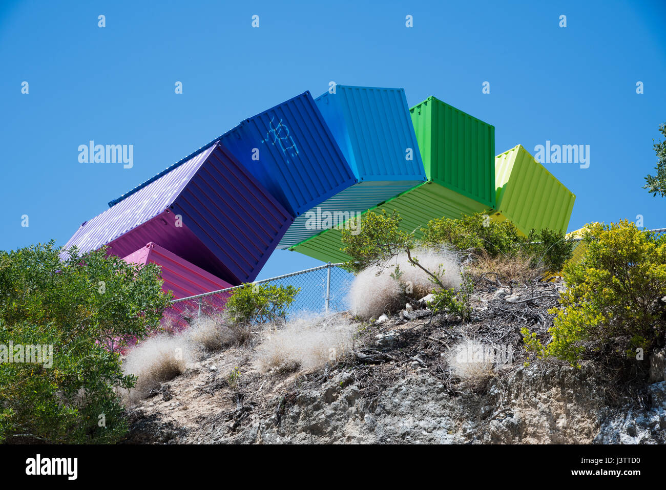 Colourful rainbow sea container sculpture by Marcus Canning on beach ...