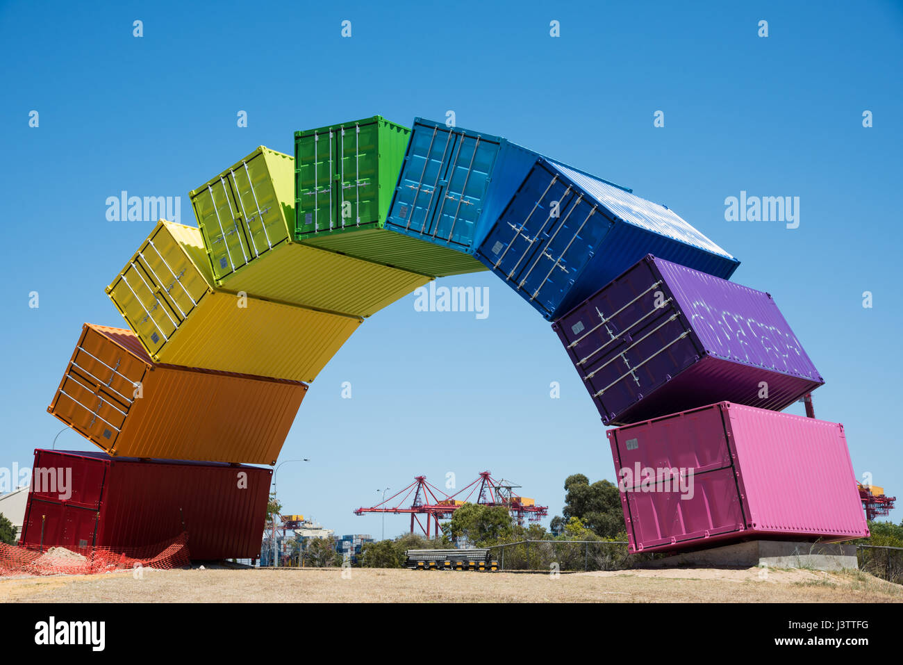 Arched rainbow sea container sculpture by Marcus Canning with port ...