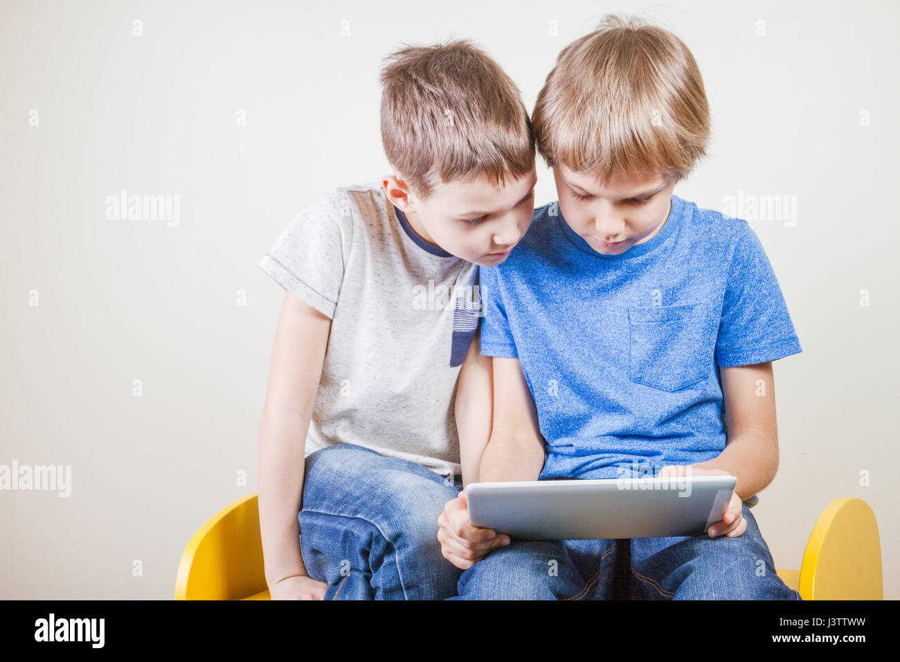 Kids playing on tablet pc together. Children looking at computer Stock ...