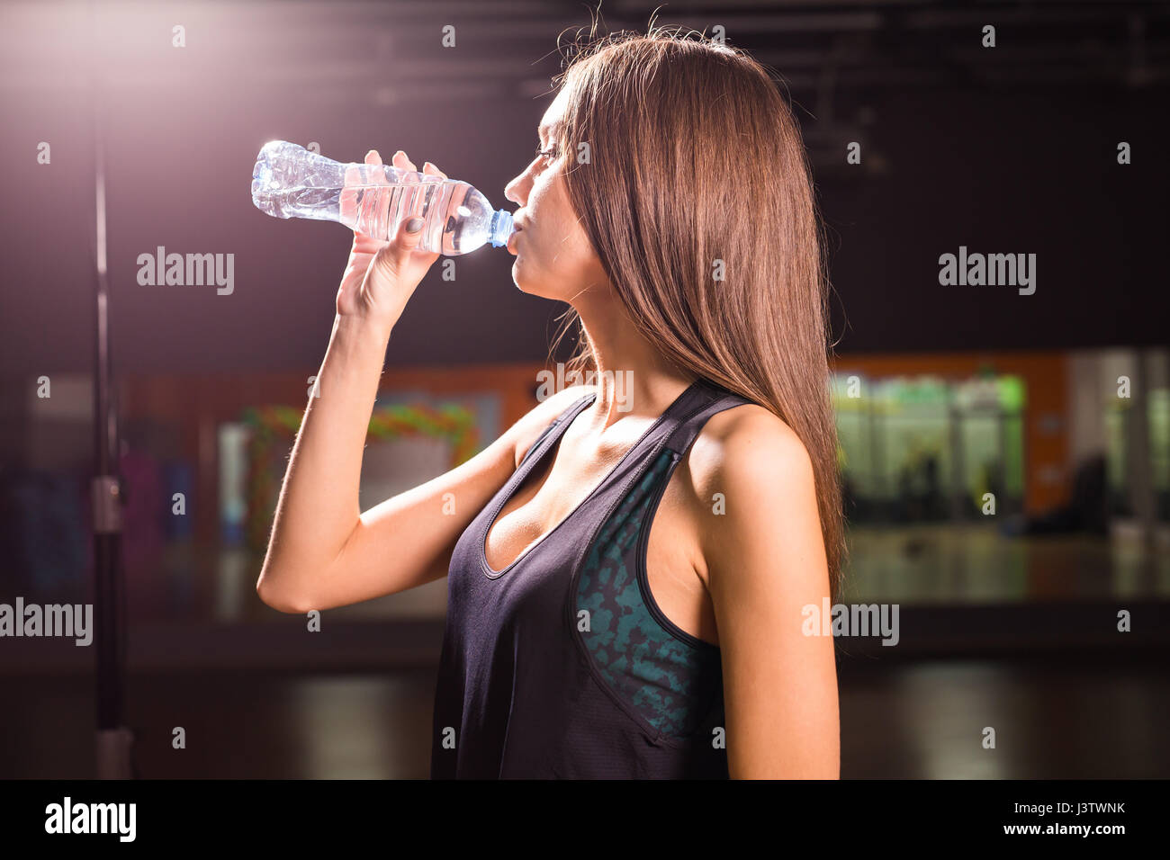 Profile of beautiful woman going to drink some water from plastic ...