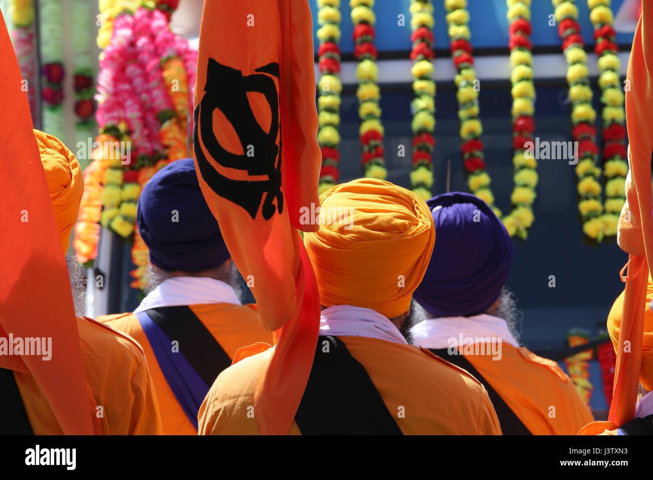 Sikh religion people with orange flags and dresses during the religious ...