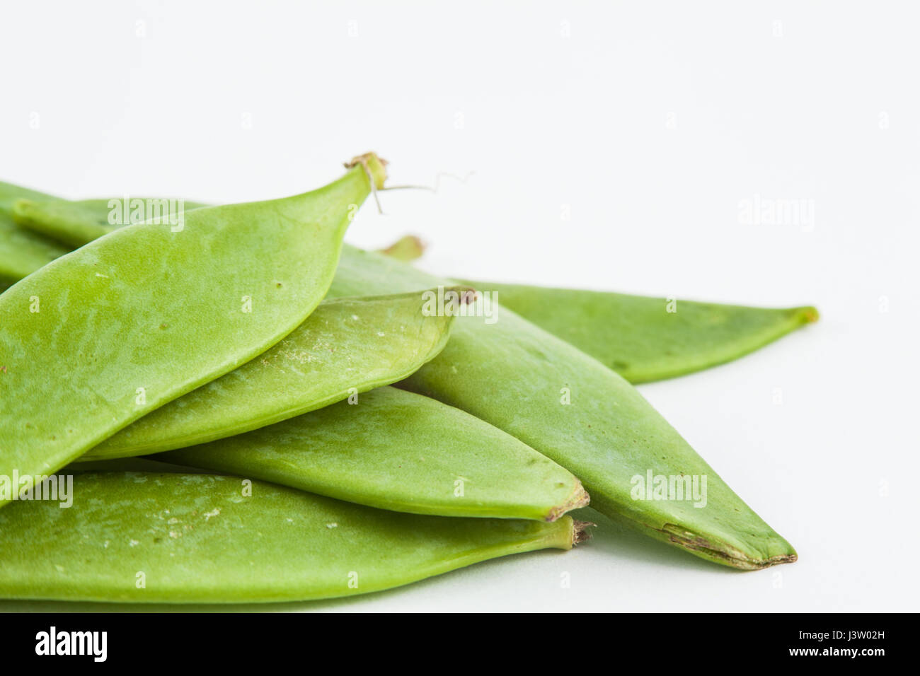 Green peas (Pisum sativum) isolated in white background Stock Photo - Alamy
