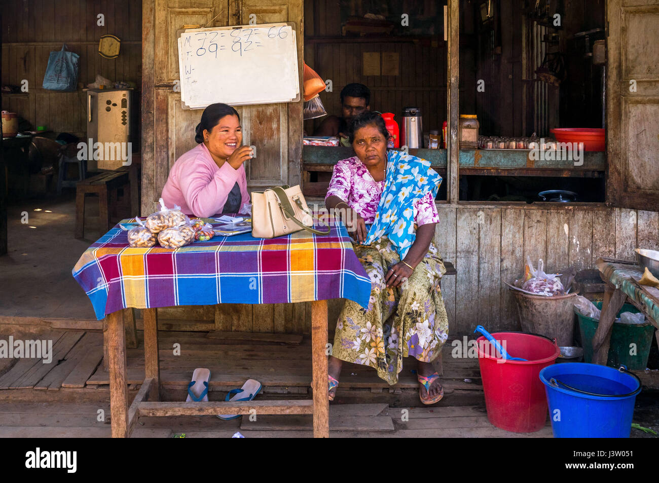 Two ladies chatting while selling their ware in Moreh, Manipur, India ...