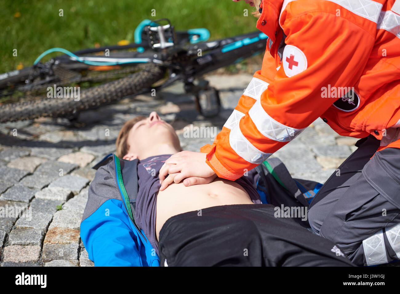 Professional paramedic giving unconscious young man first aid Stock ...
