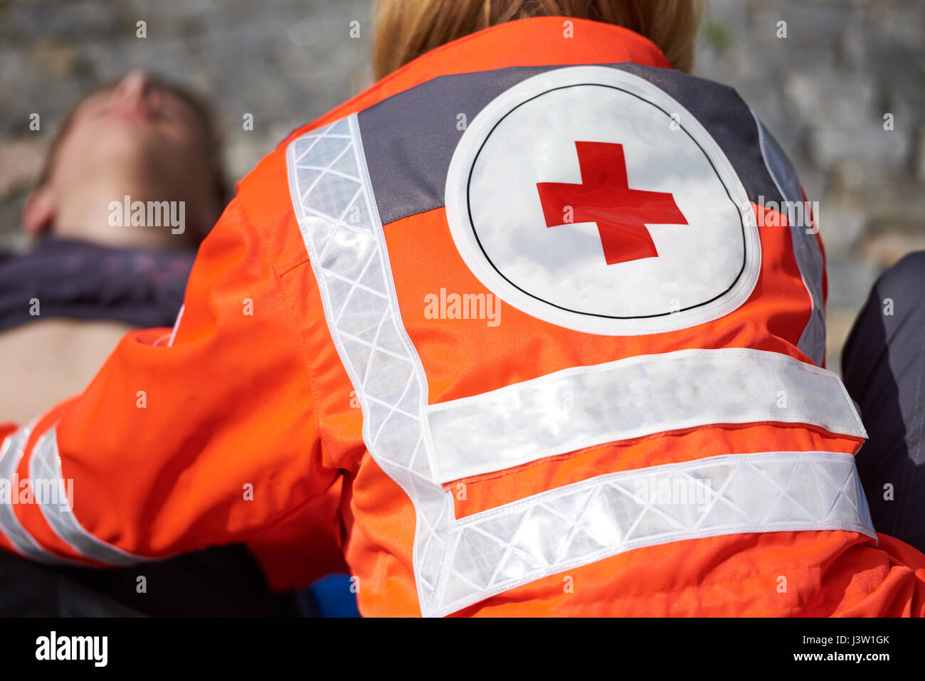 Professional paramedic giving unconscious young man first aid Stock ...