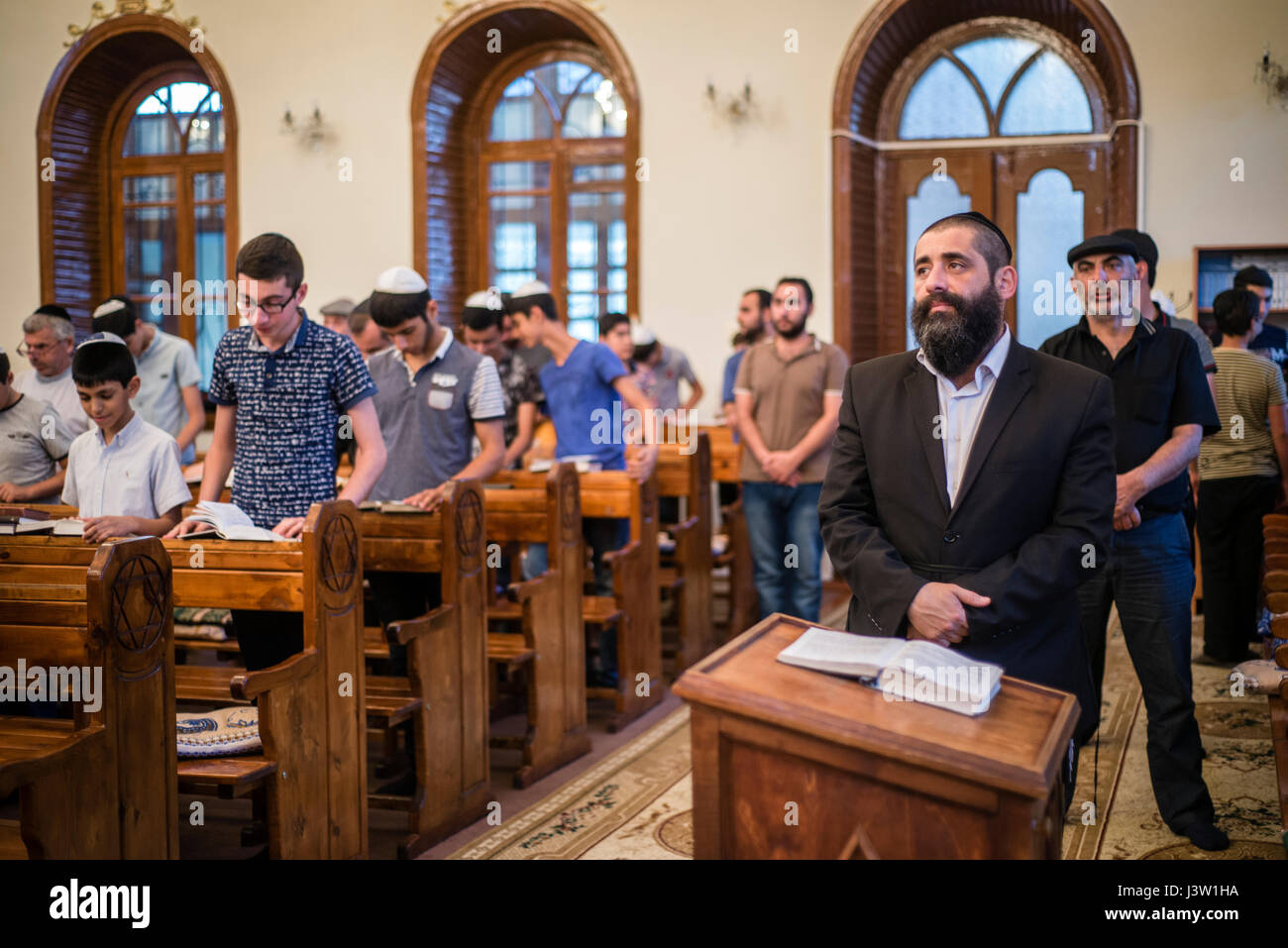 Rabbi is reading in torah at synagogue hi-res stock photography and ...