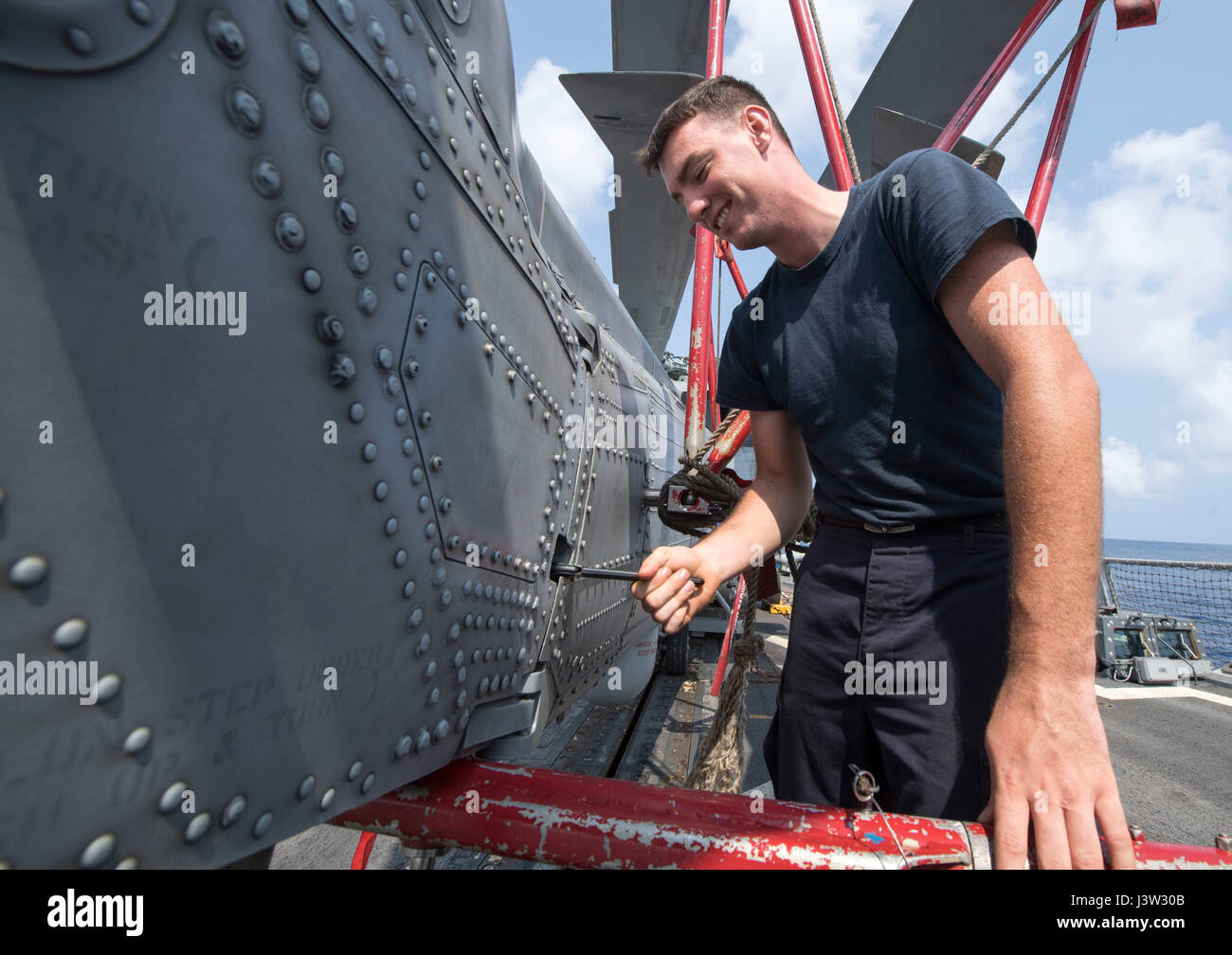 Aviation Machinist’s Mate 3rd Class Leo Stapleton, from Boston, loosens ...