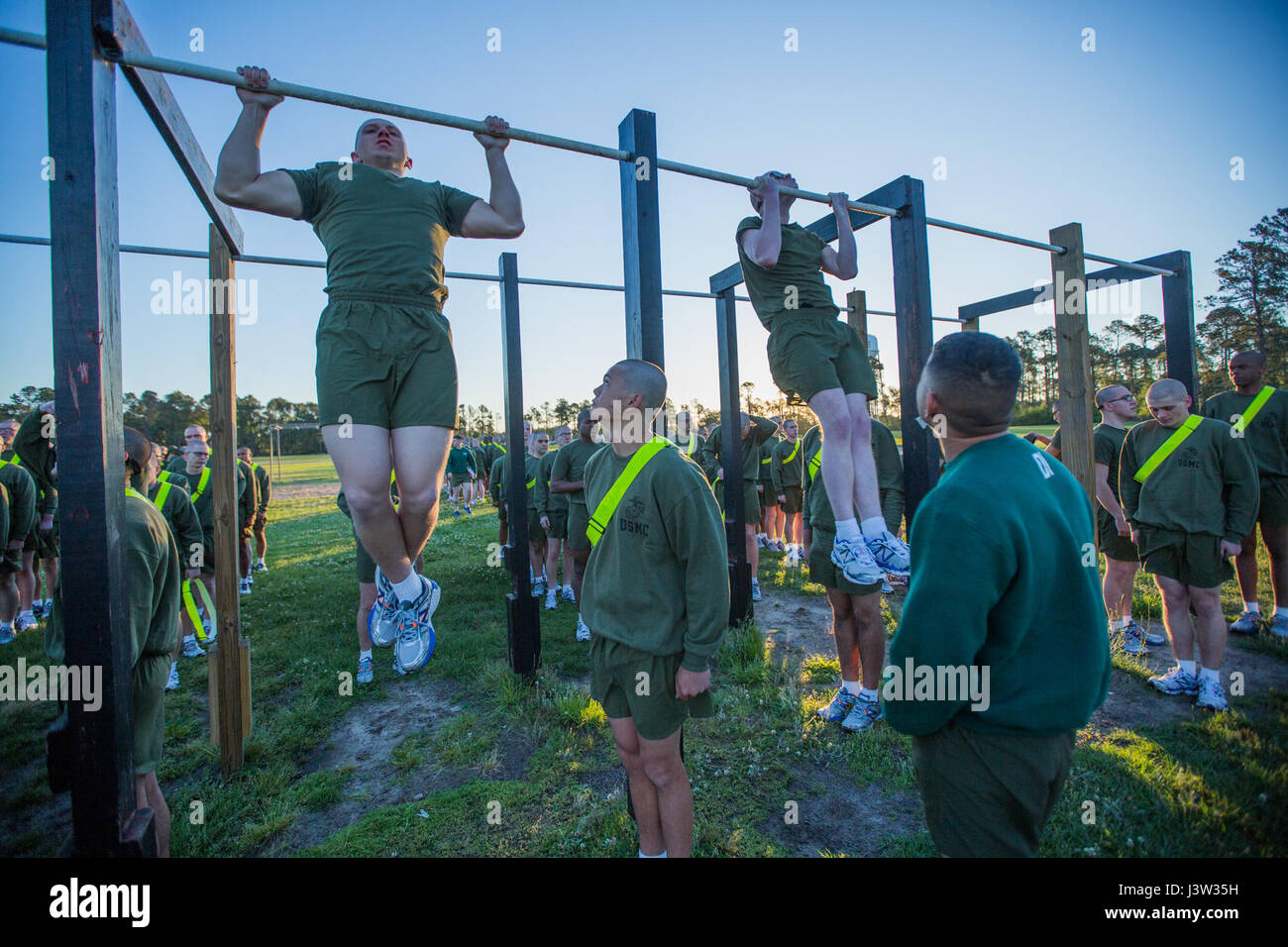 Recruits do pullups during an initial strength test April 7, 2017, on ...