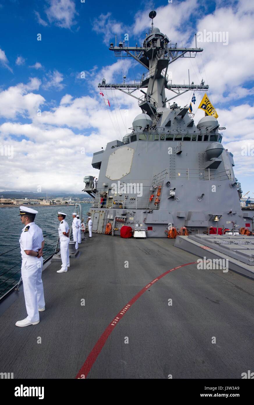 Sailors stand watch on the rails of the Arleigh Burke-class guided ...