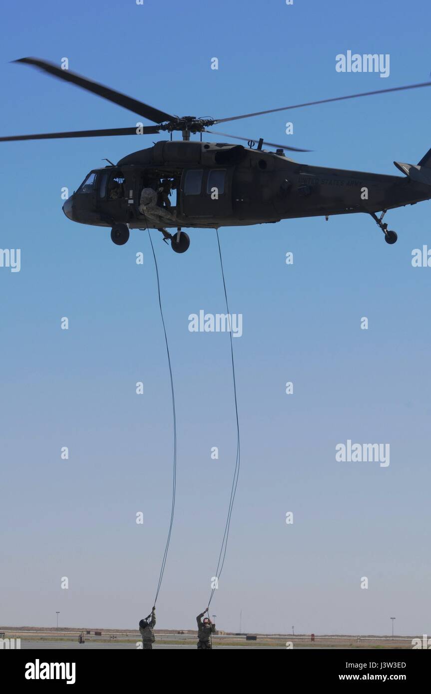 A U.S. Army Soldier prepares to rappel out of a UH-60 helicopter on ...