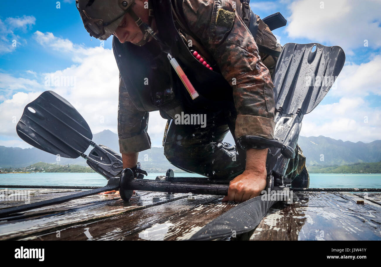A U.S. Reconnaissance Marine climbs onto the pier prior to conducting ...