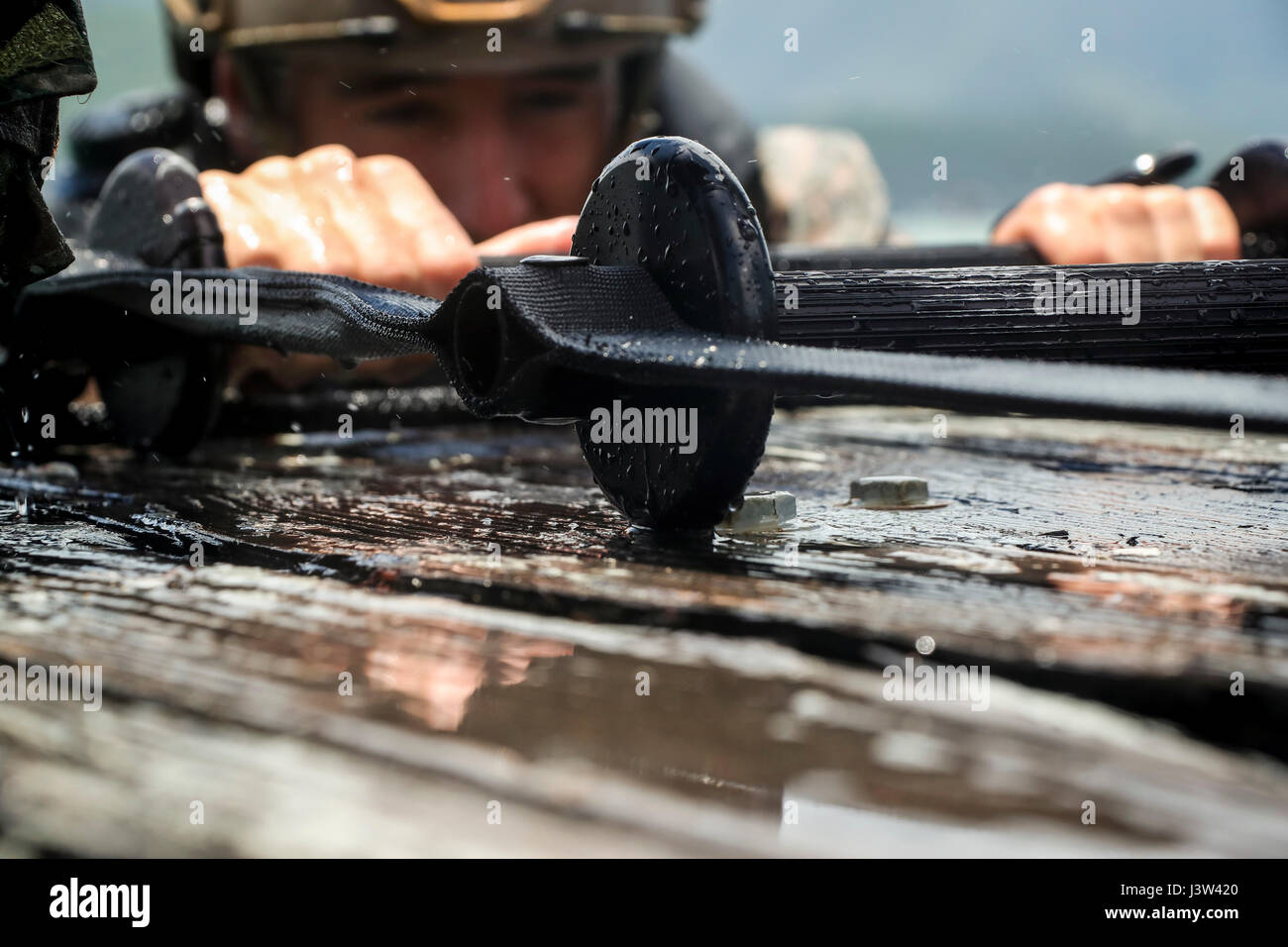 A U.S. Reconnaissance Marine climbs onto the pier prior to conducting ...
