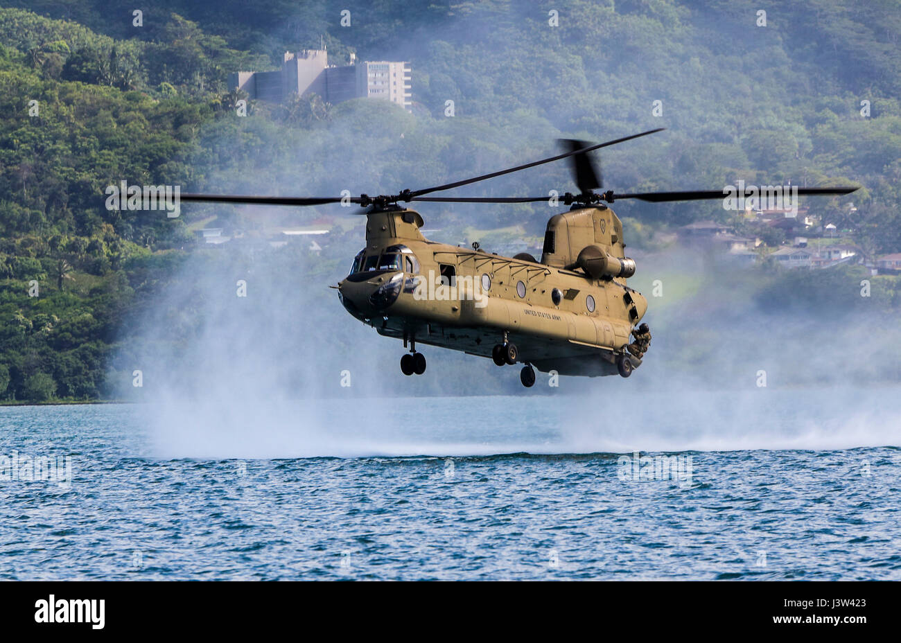 A U.S. Army CH-47 Chinook hovers off the coast of Hawaii prior to ...