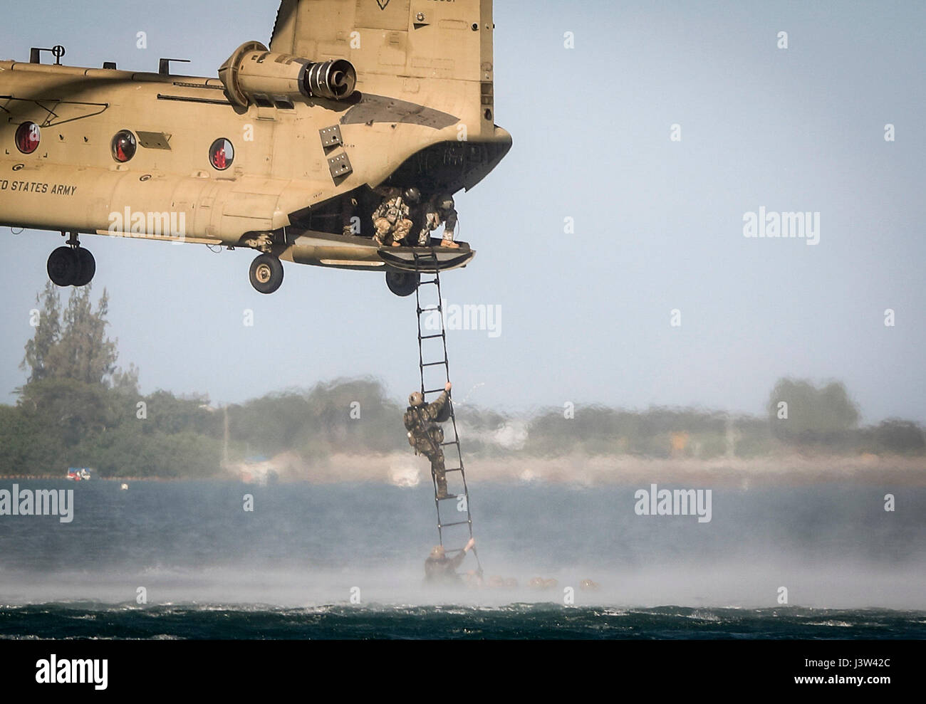 A U.S. Reconnaissance Marine climbs into a CH-47 Chinook during helo ...