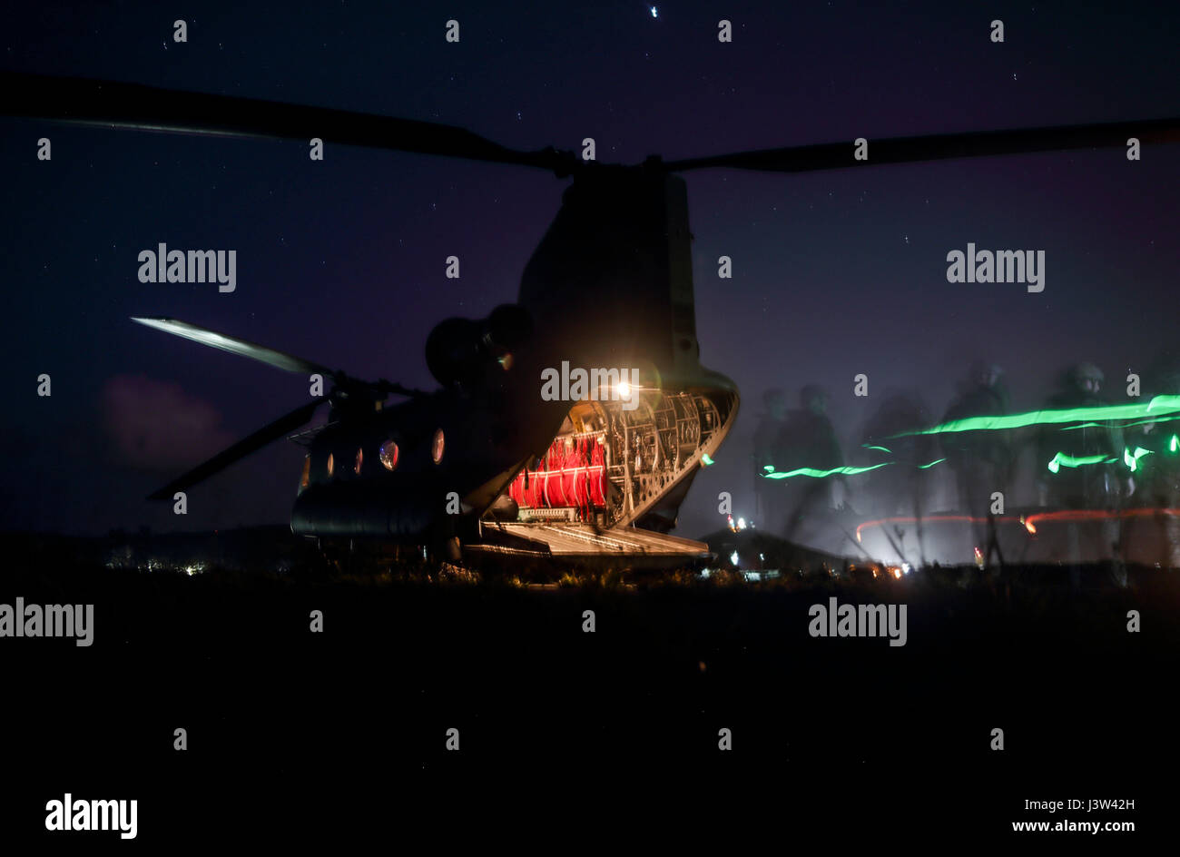 U.S. Reconnaissance Marines conduct nighttime helo-casting training at ...