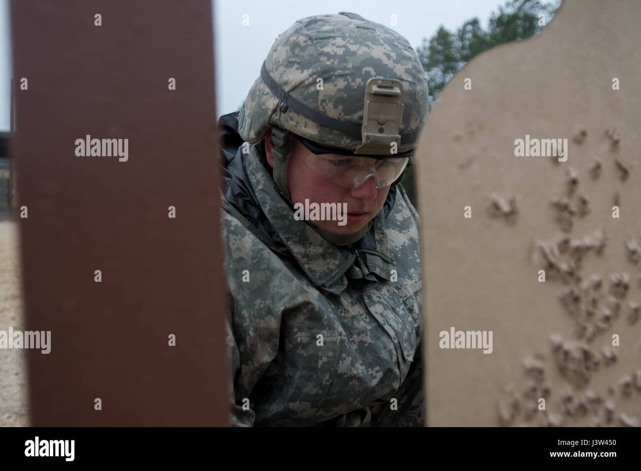 Spc. Joseph Smith inspects his shot group to determine adjustments he ...