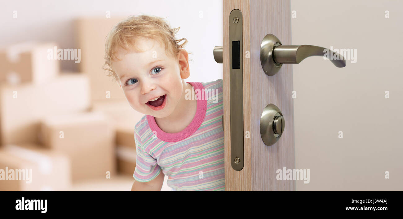 happy kid behind door in new room Stock Photo - Alamy