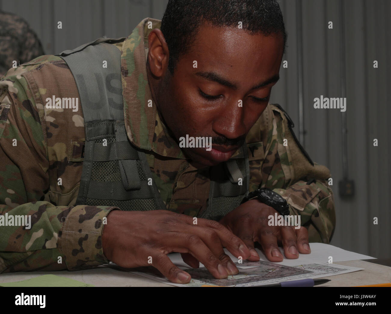 U.S. Army Sgt. Daniel Beachum prepares for the land navigation phase of ...